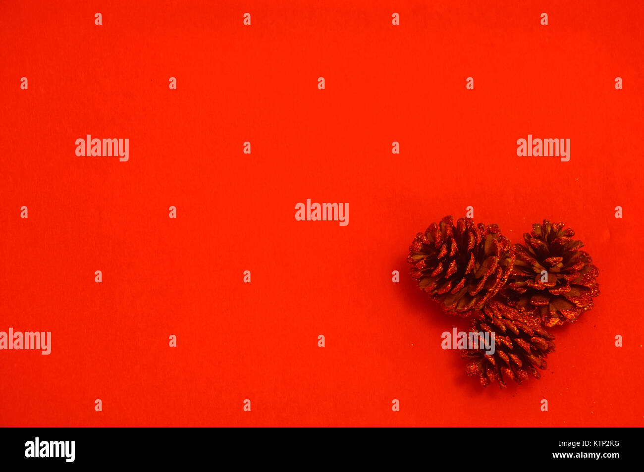 Close up three small cones lying on bright red surface beautiful ...