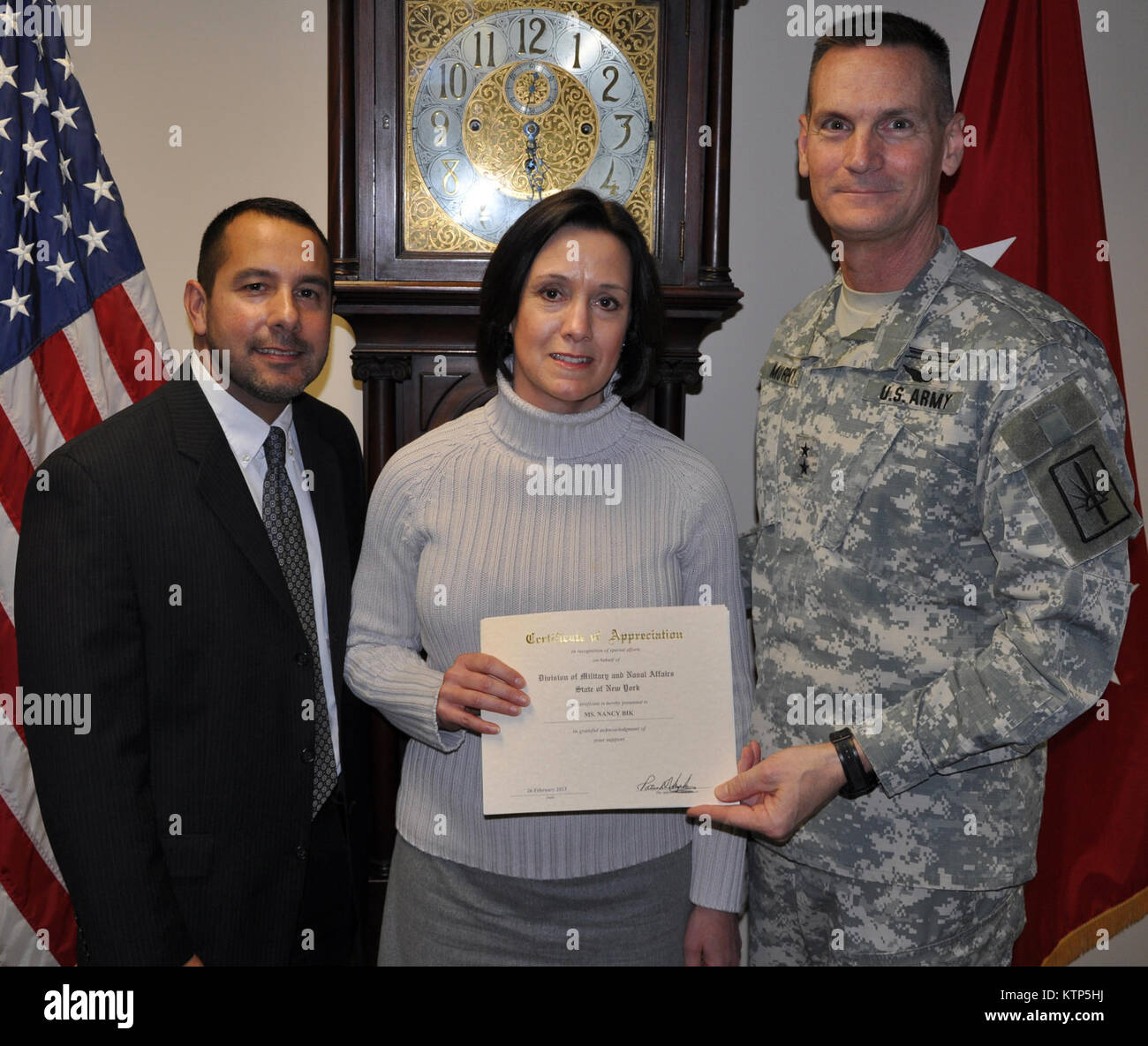 LATHAM, N.Y.-- Ms. Nancy Bik (middle) receives a Certificate of ...