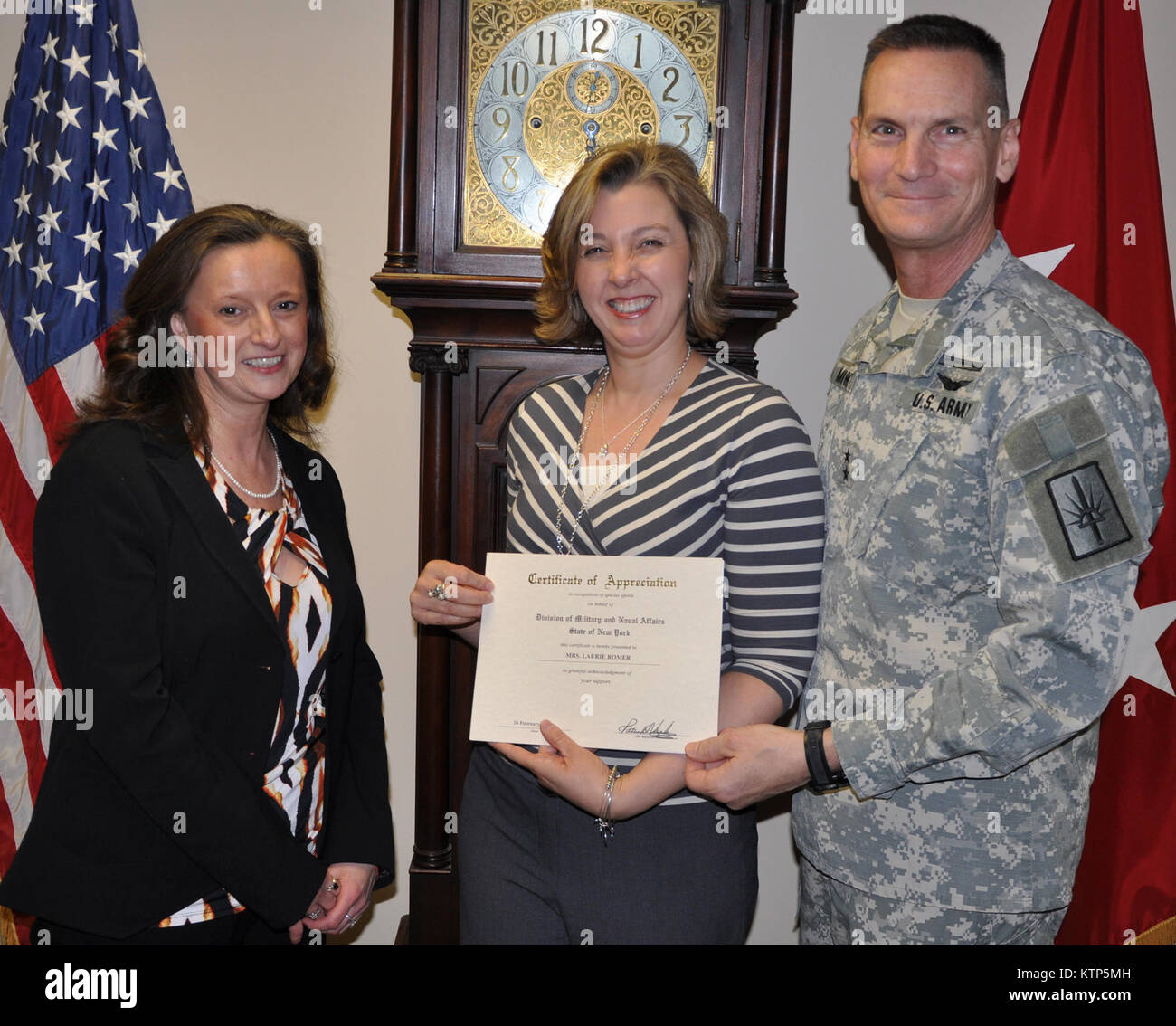 LATHAM, N.Y.-- Mrs. Laurie Romer (middle) receives a Certificate of ...