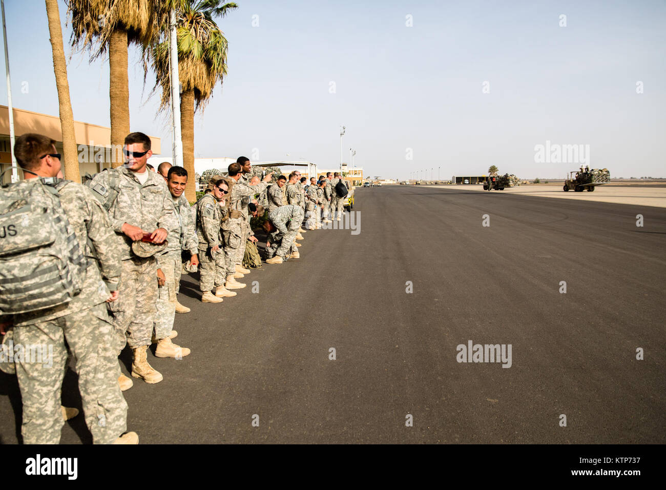 U.S. Army soldiers from the 42nd Combat Aviation Brigade load their ...