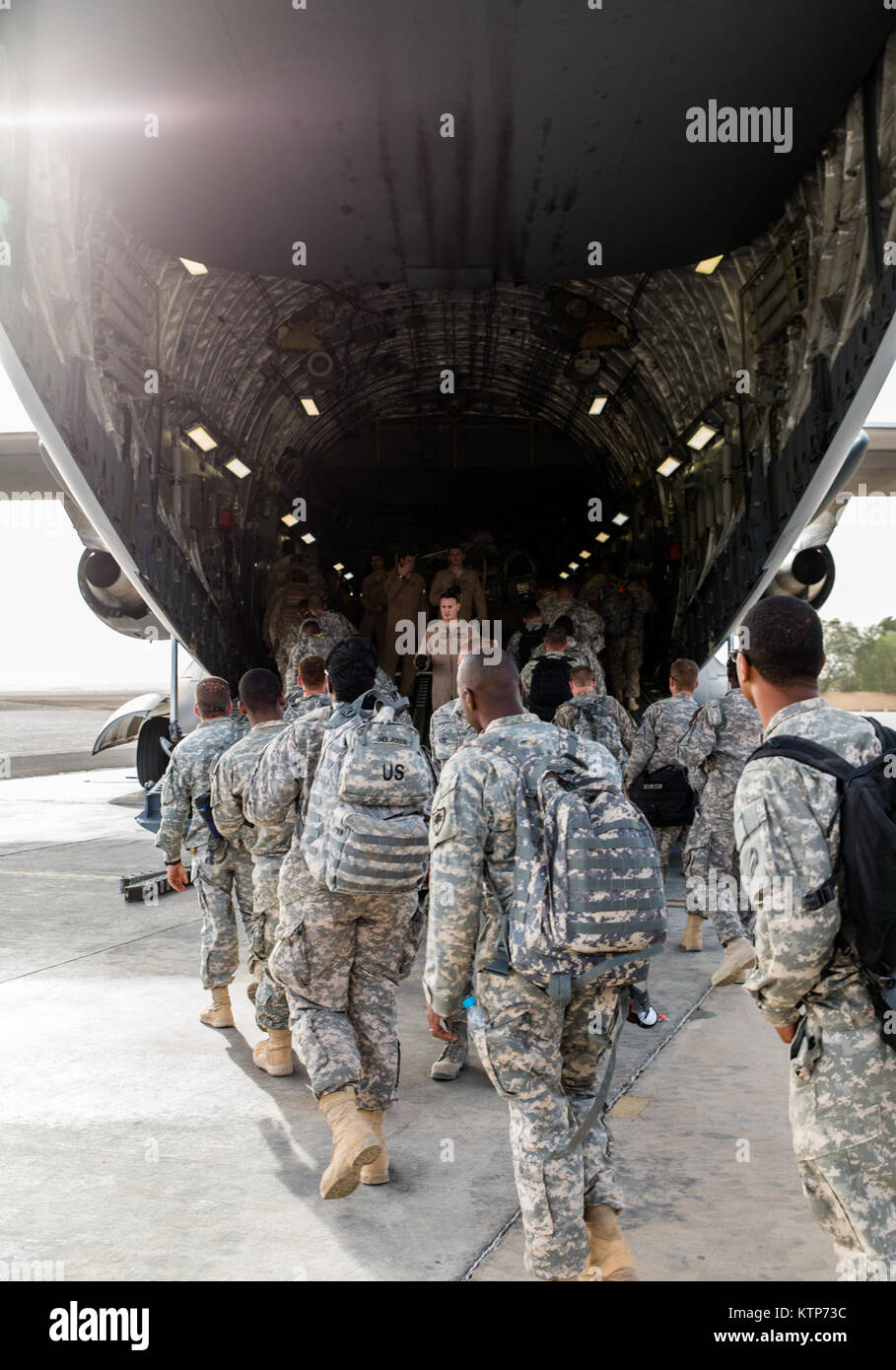 U.S. Army soldiers from the 42nd Combat Aviation Brigade load their ...