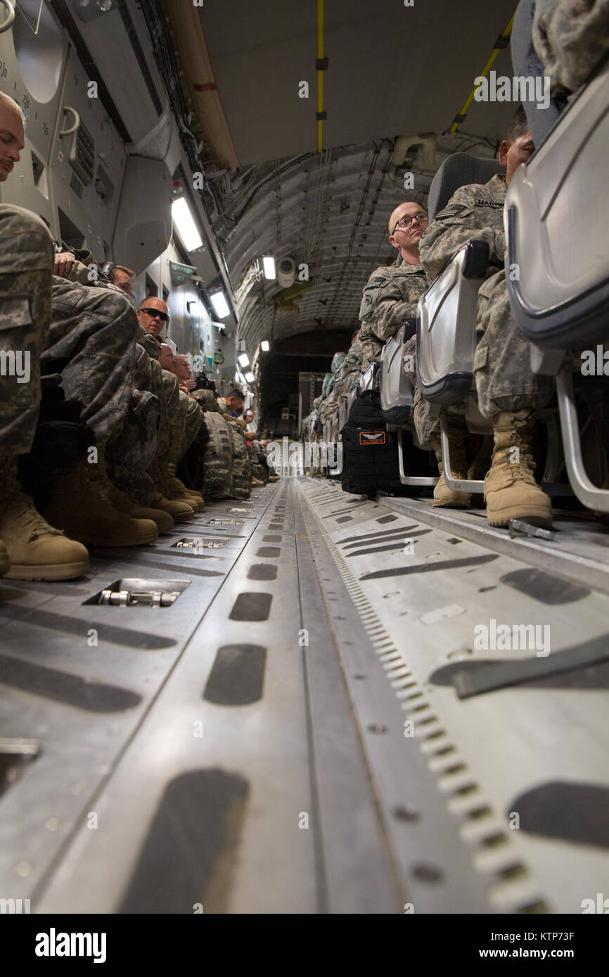 U.S. Army soldiers from the 42nd Combat Aviation Brigade load their ...