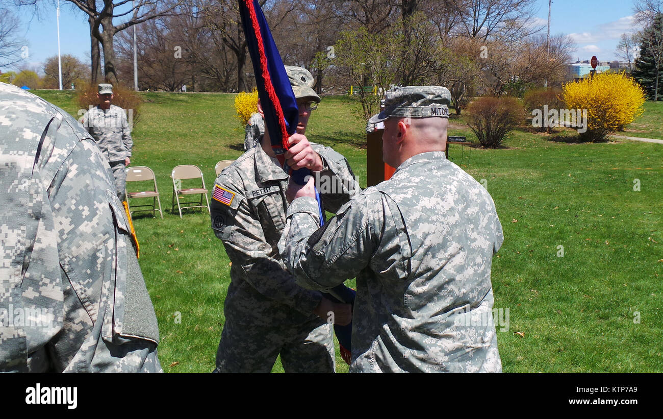 Incoming Command Sgt. Maj. Joseph Mitchell accepts the battalion colors ...