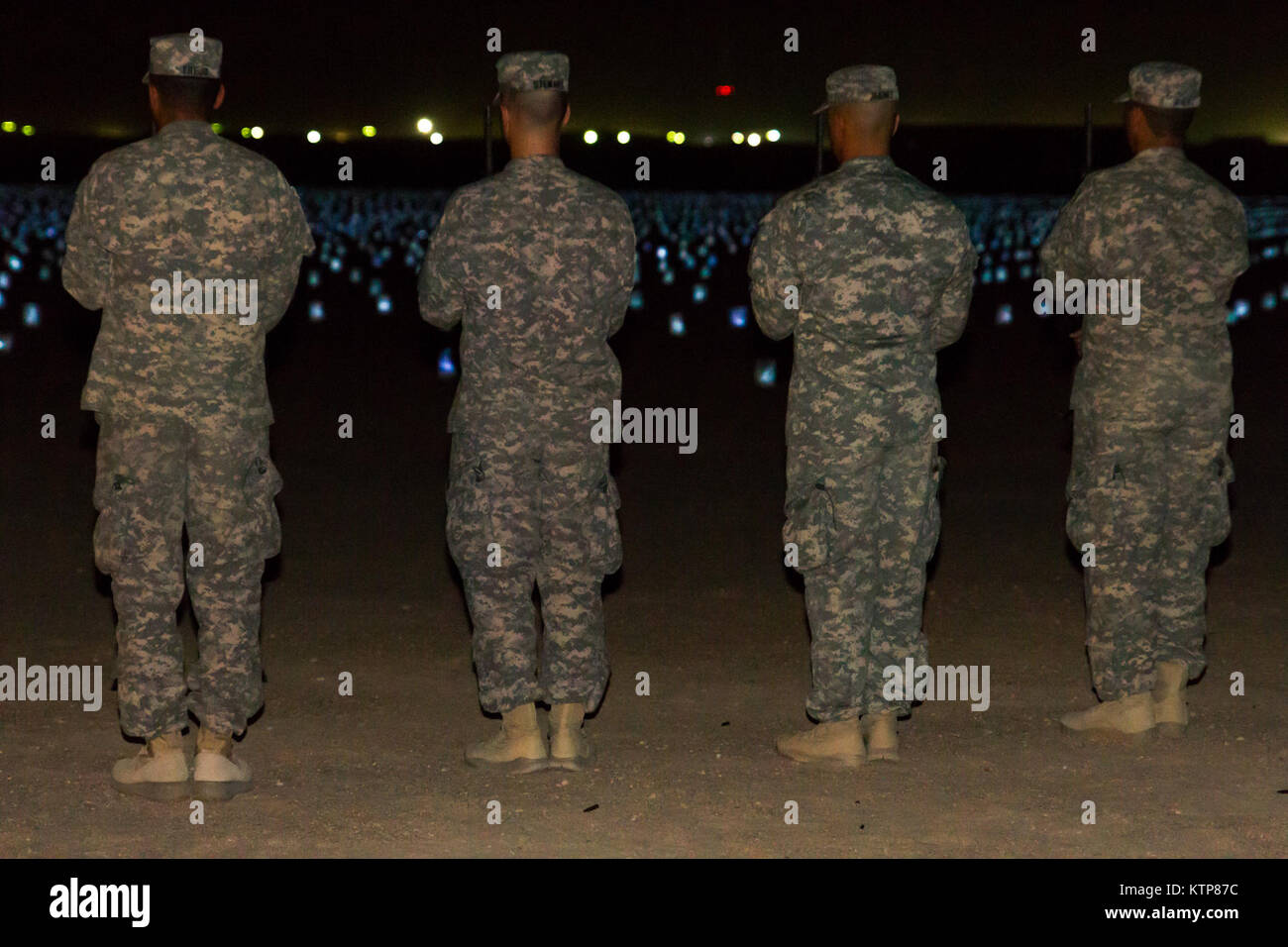 An honor guard of soldiers deployed to Kuwait stand watch during a ...