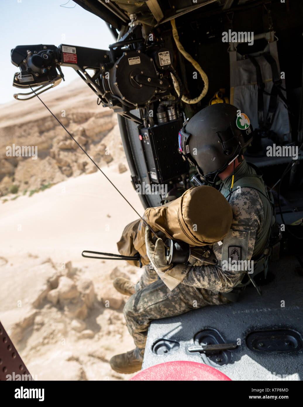 Spc. Giles Dunlop, a crew chief, lowers a SKEDCO litter to a simulated ...