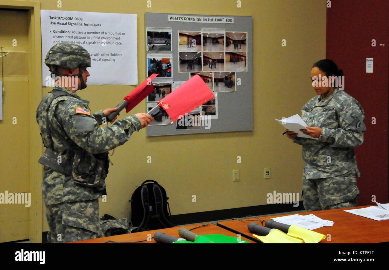 Spc. Ben Shehan, left, demonstrates hand signals to Sgt. Erica Cruz for ...