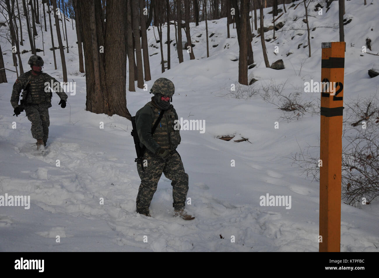 Two 42nd Infantry Division Soldiers trudge in from the land navigation ...