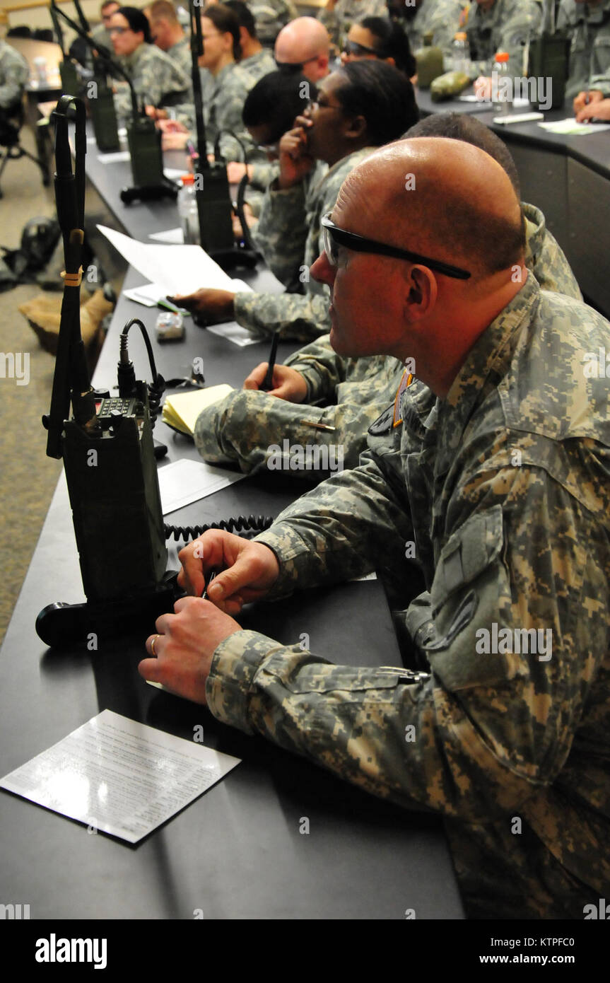 Sgt. Maj. Nathan Hawker listens as he and a group of other 42nd ...