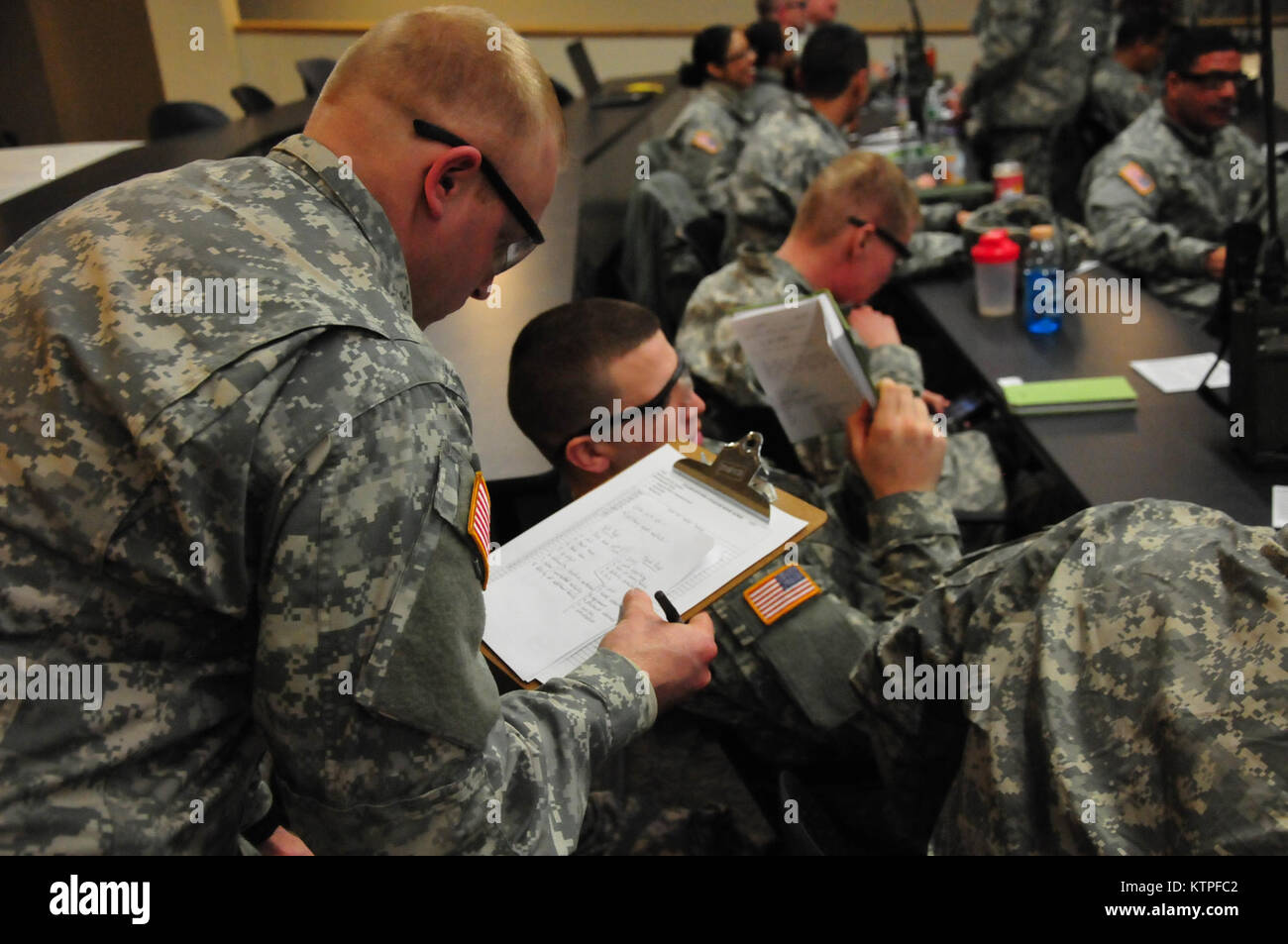 Pfc. Kyle Winne, left, verifies a situation report from Sgt. Reid ...