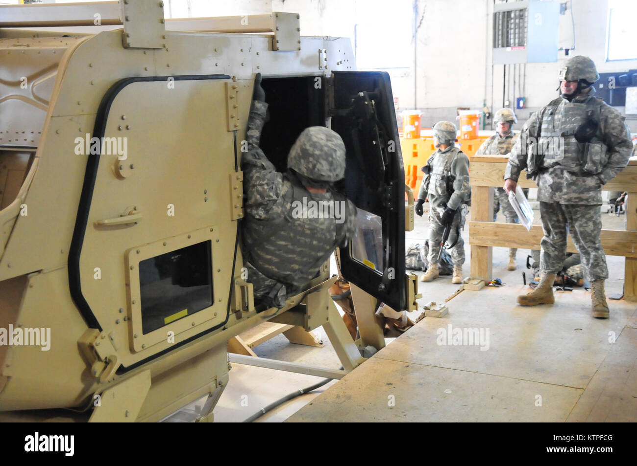 A 42nd Infantry Division Soldier emerges from the Humvee rollover ...