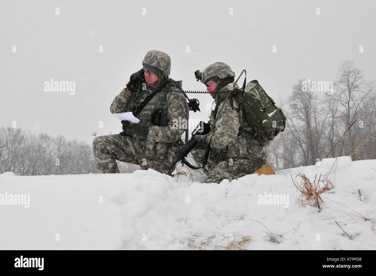 Capt. Chad Vincton and Spc. Patrick Kelly report enemy activity using a ...