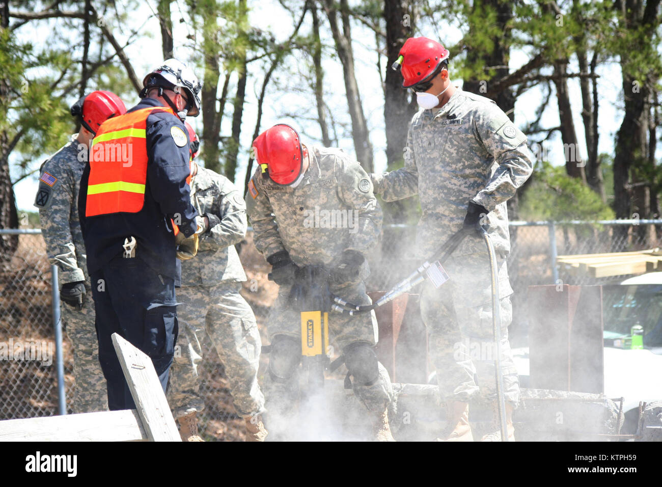 U.S. Army Spec. Andrew Hisel uses a jack hammer to break through ...