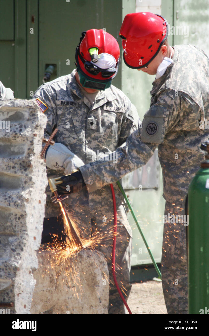 U.S. Army Spc. Andrew Paulsen practices with a blow torch to cut ...