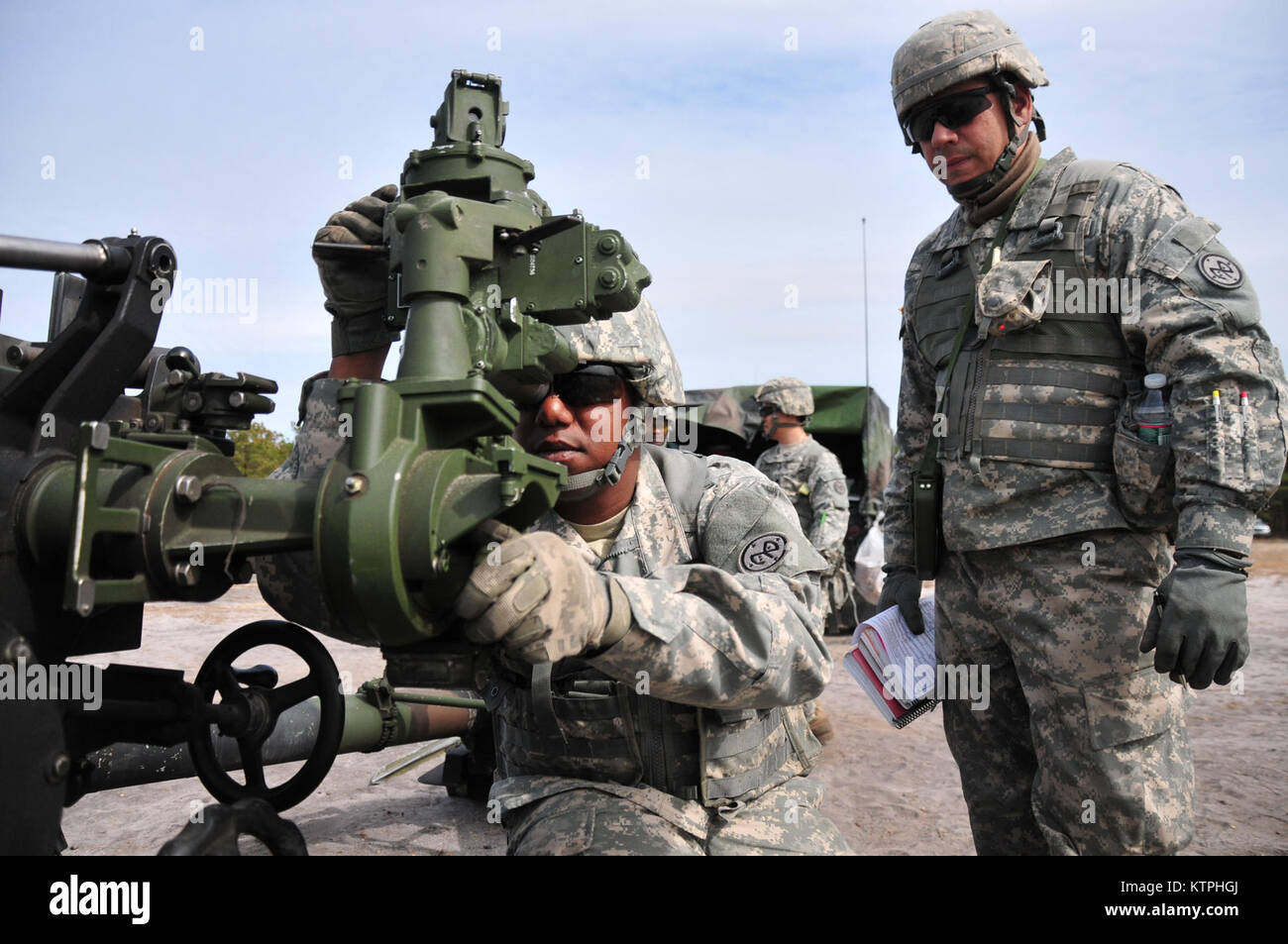 Sgt. Robert Gadsden looks throught the aiming device in order to line ...