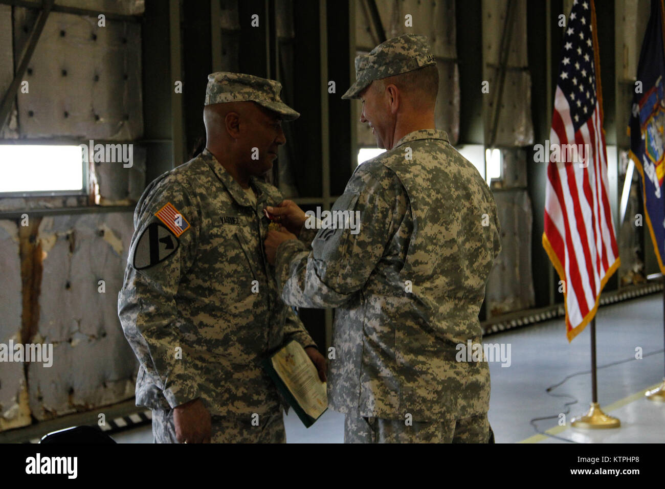 Col. Jack James, the 42nd Combat Aviation Brigade commander, pins the ...