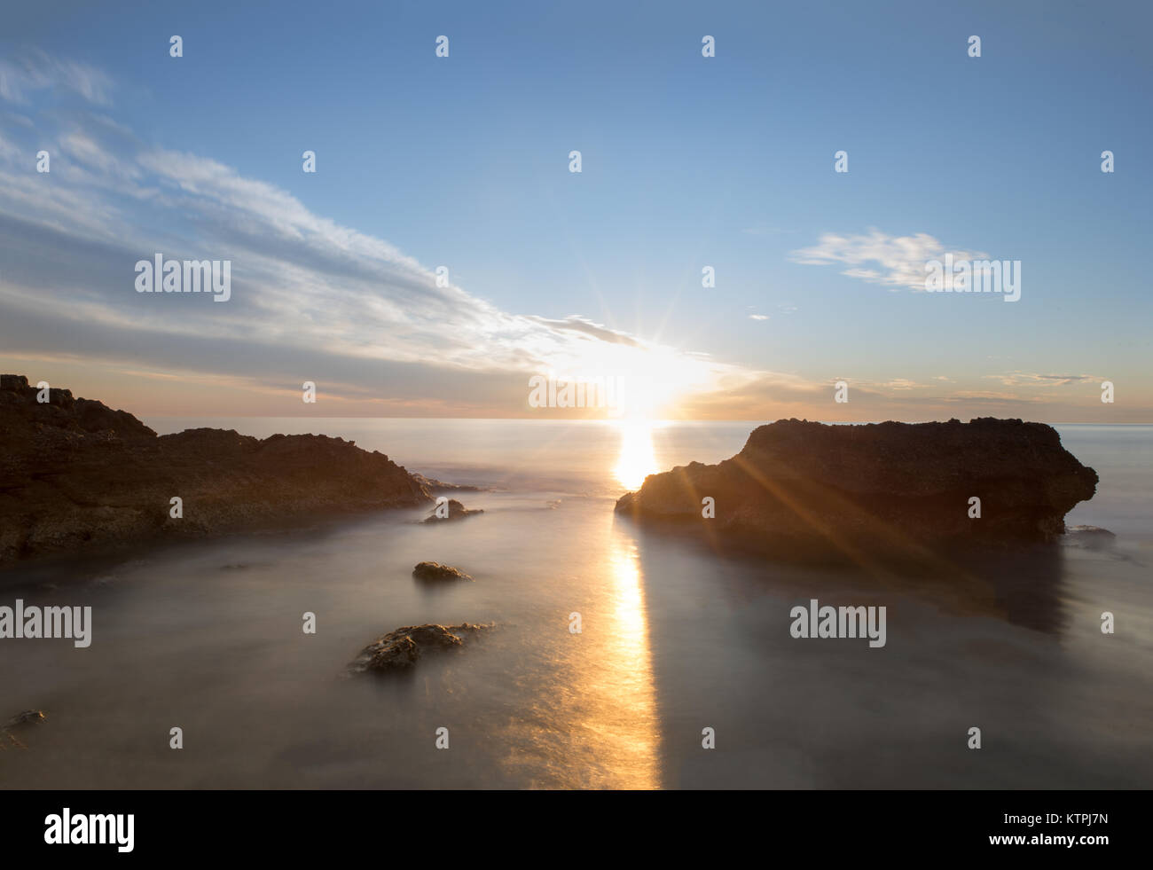 The calm sea in a very cloudy sunset in Spain Stock Photo - Alamy