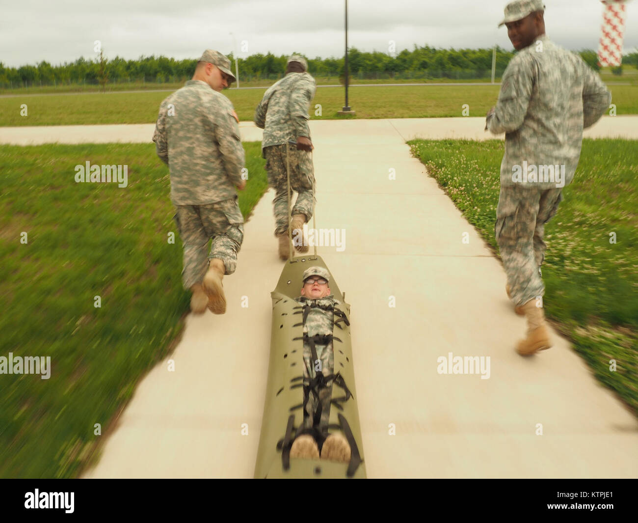 Soldiers drag Spc. Jordan Kneebone of the 42nd Infantry Division ...