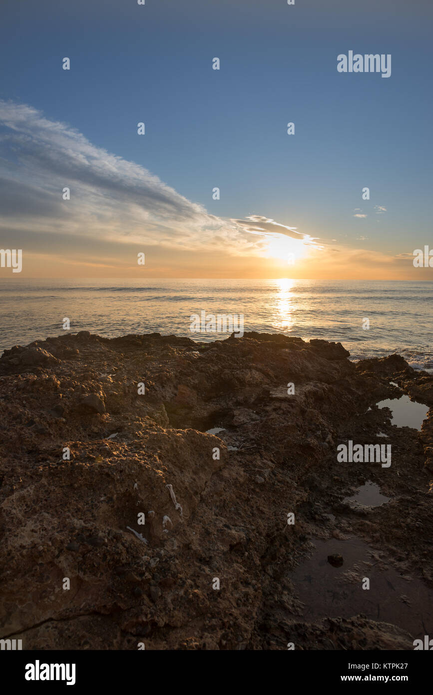 The calm sea in a very cloudy sunset in Spain Stock Photo - Alamy