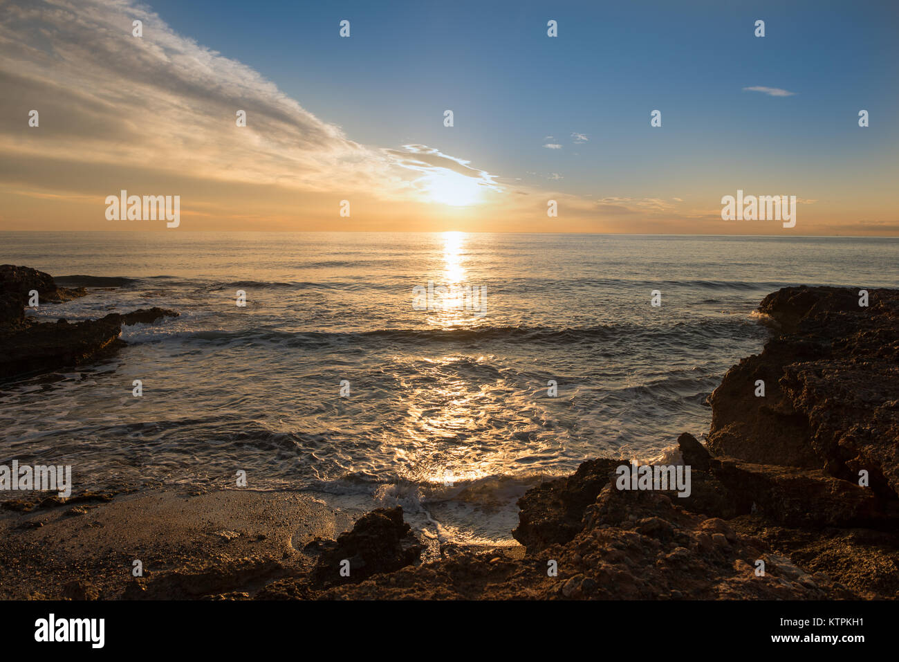 The calm sea in a very cloudy sunset in Spain Stock Photo - Alamy