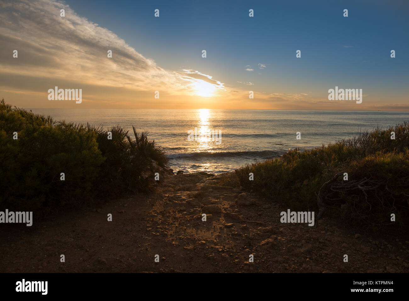 The calm sea in a very cloudy sunset in Spain Stock Photo - Alamy
