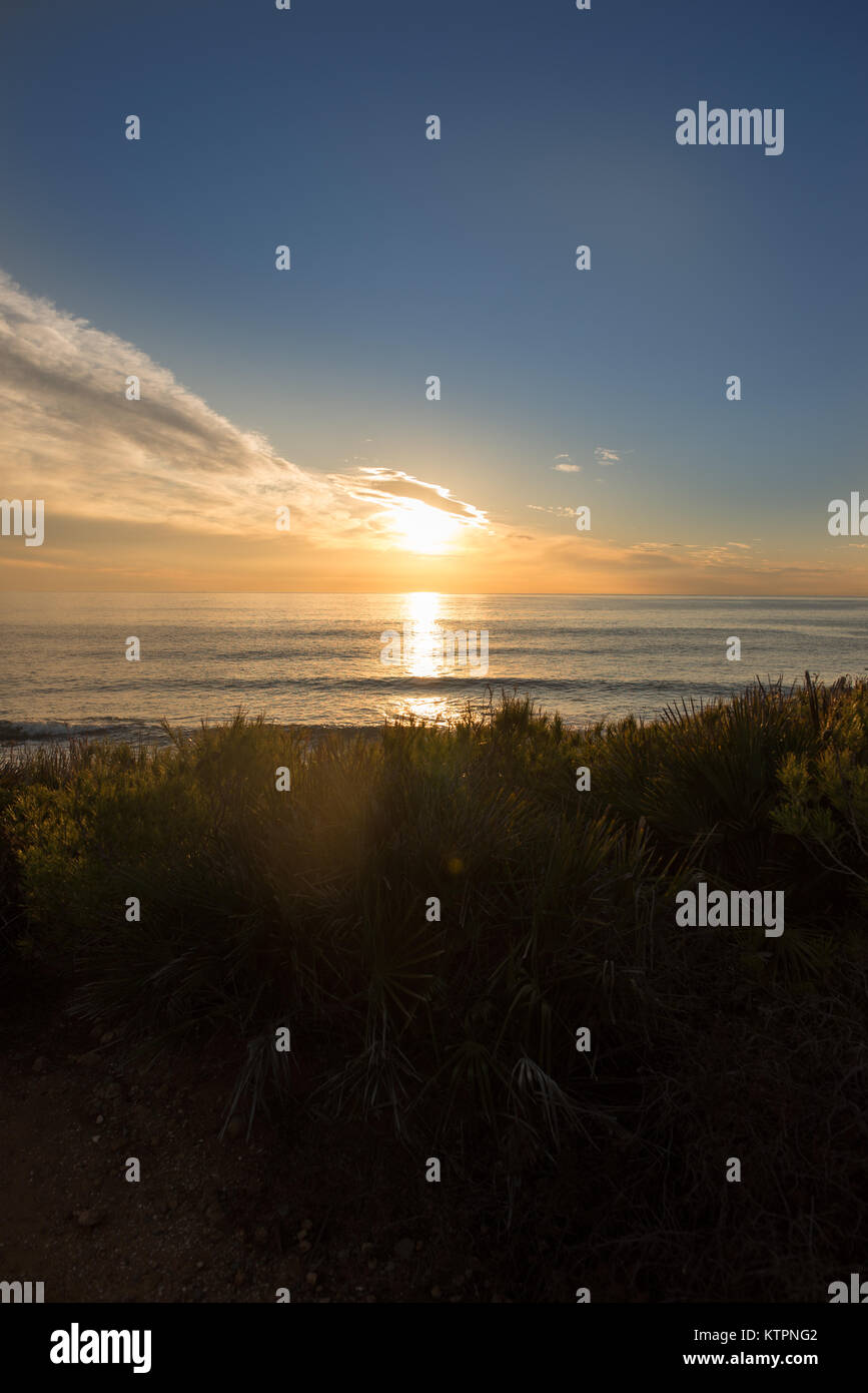 The calm sea in a very cloudy sunset in Spain Stock Photo - Alamy