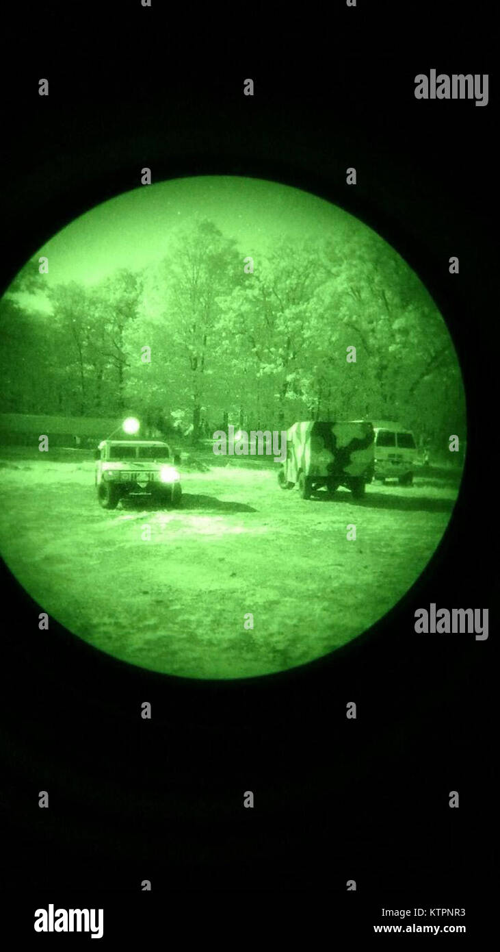 A night vision shot shows New York Army National Guard humvees being ...