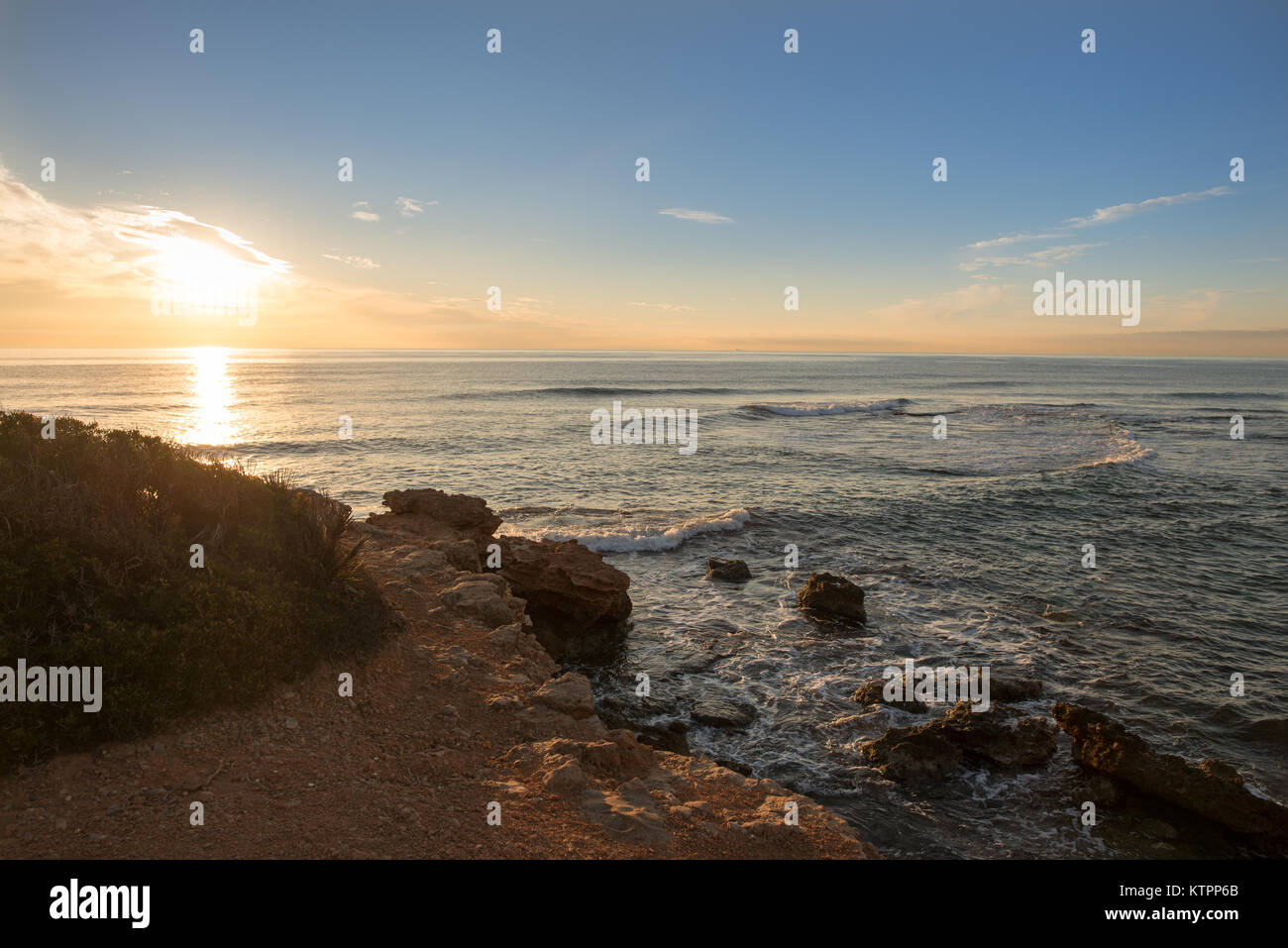 The calm sea in a very cloudy sunset in Spain Stock Photo - Alamy