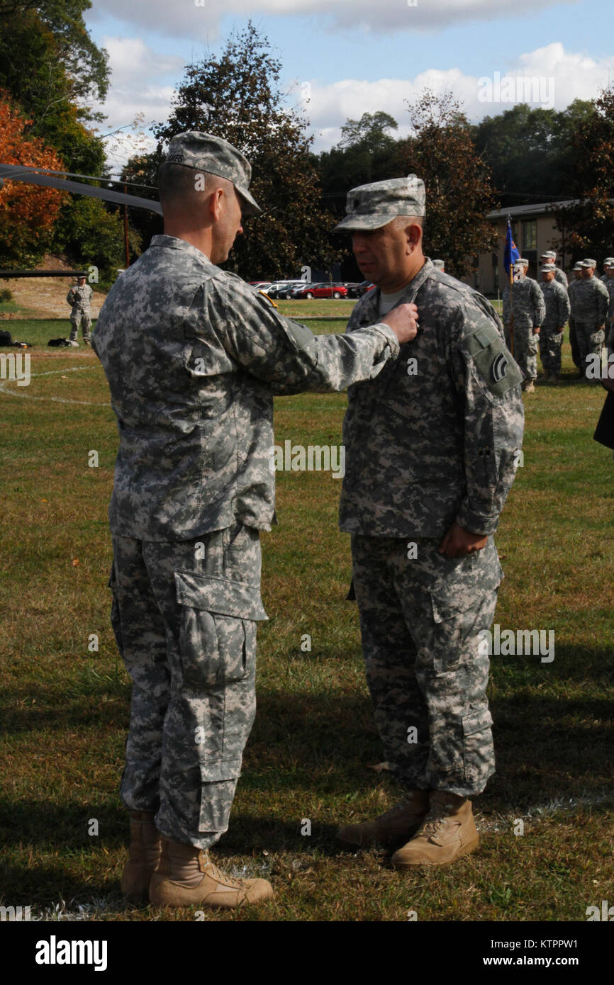 Col. Jack James, the 42nd Combat Aviation Brigade commander, pins the ...