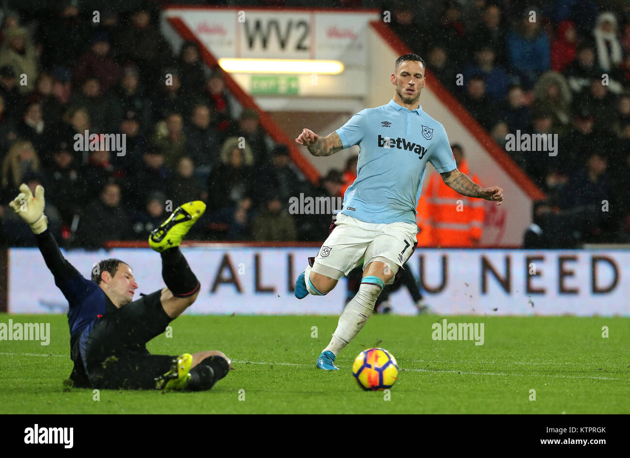 AFC Bournemouth goalkeeper Asmir Begovic (left) slips as he tries to ...