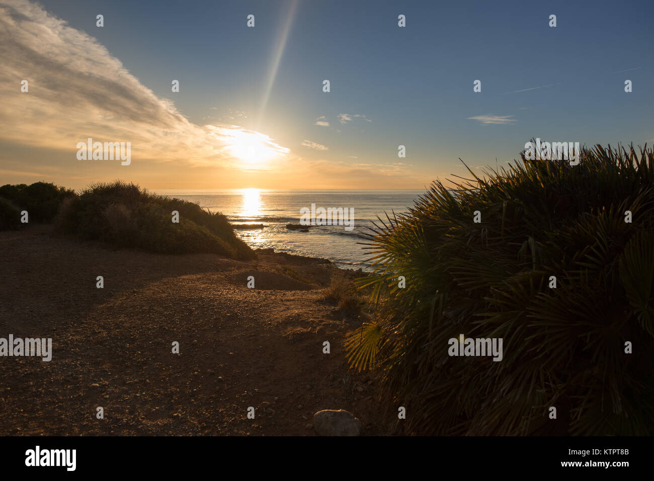 The calm sea in a very cloudy sunset in Spain Stock Photo - Alamy