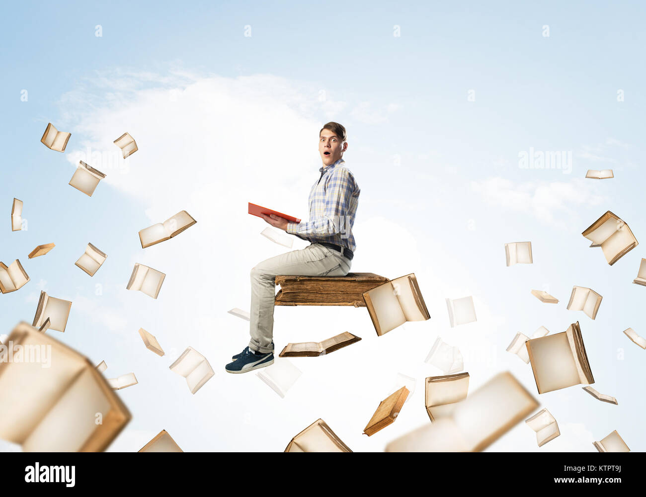 Man reading book and many of them flying in air Stock Photo - Alamy