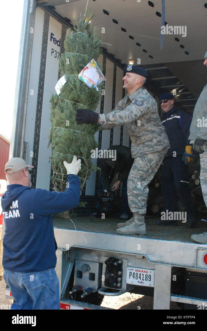 New York Air National Guard Tect. Sgt. Michael Crisalli helps load the ...