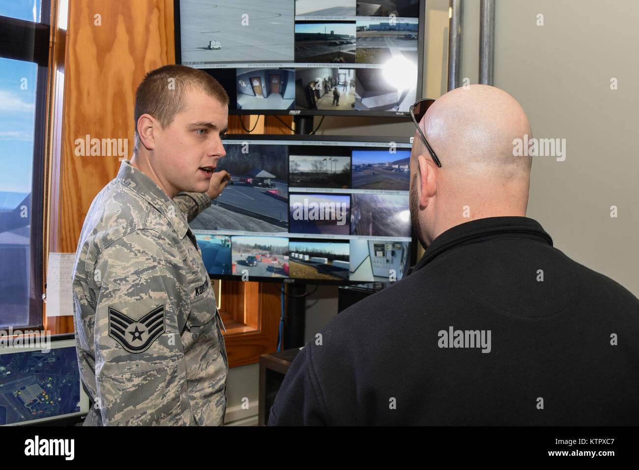 Staff Sgt. Michael Kortright, 105th Base Defense Force, confers with ...