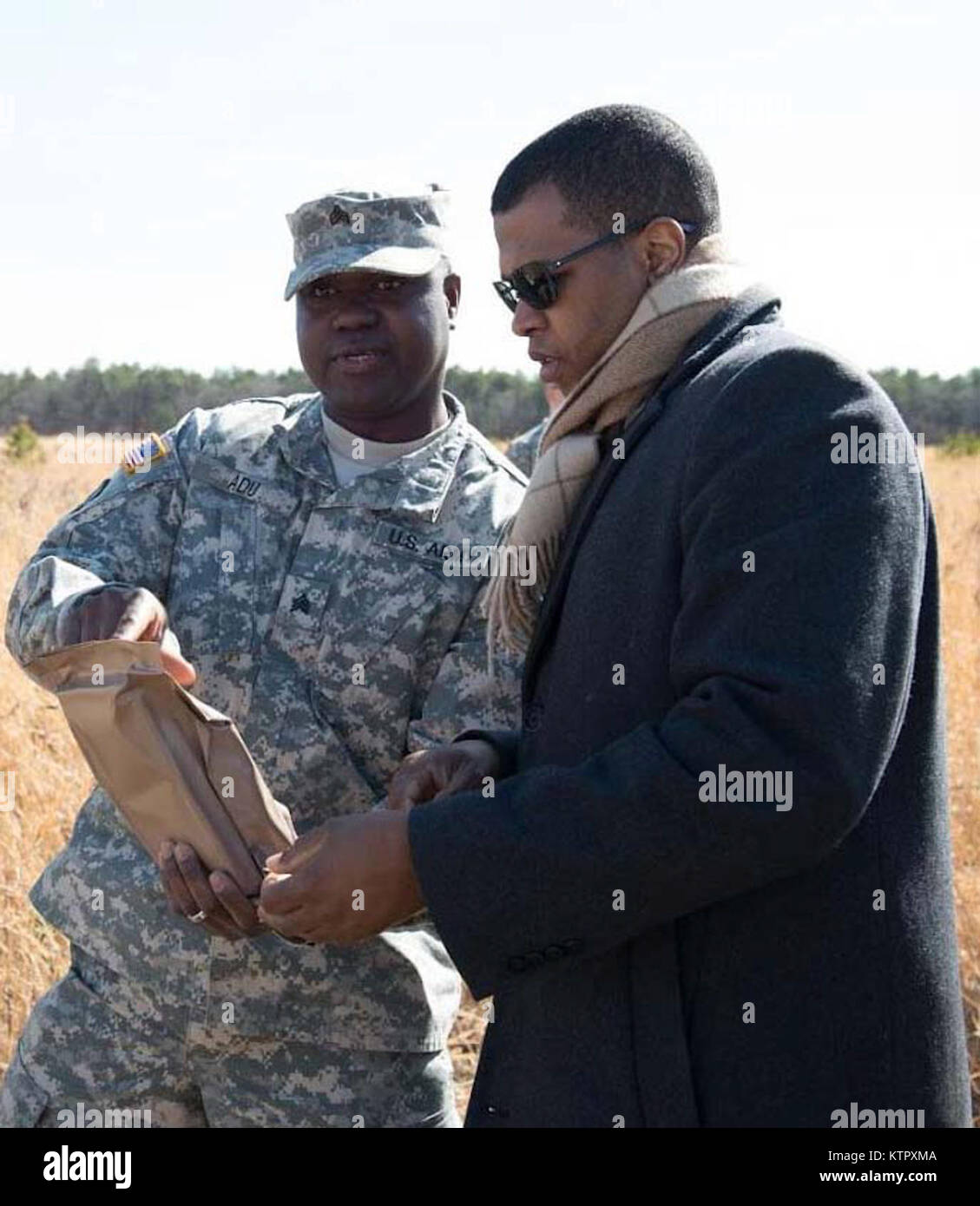 New York Army National Guard Sgt. Victor Adu demonstrates how to eat an ...