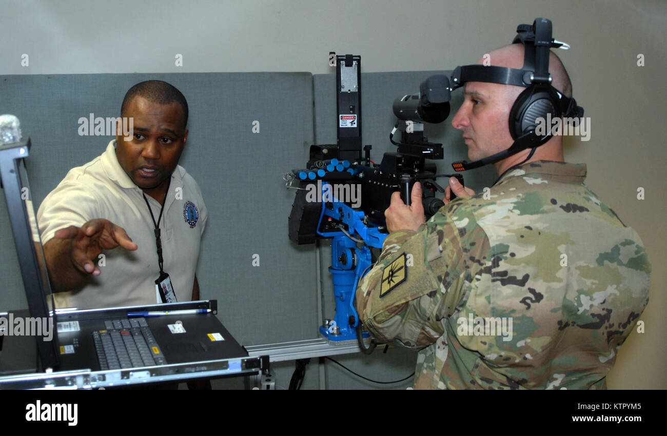 LATHAM, N.Y. -- National Guard contractor Leon Jackson (left) shows New ...