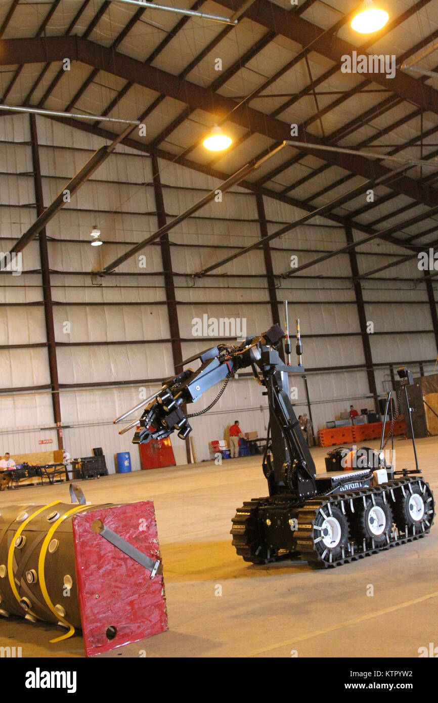A remotely-piloted bomb disposal robot hefts a package filled with 150 ...