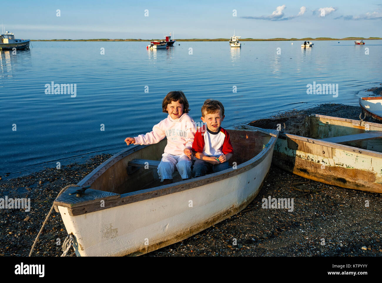 Cute kids pose for a vacation photo in a rowboat Stock Photo - Alamy