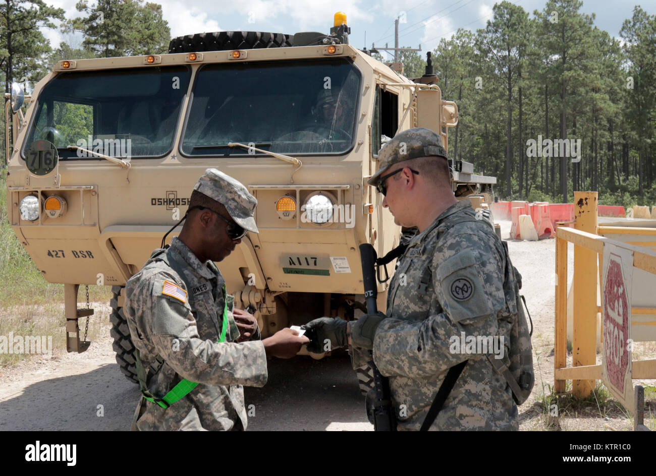Spc. Nole, conducts an identification check of a Soldier coming ...