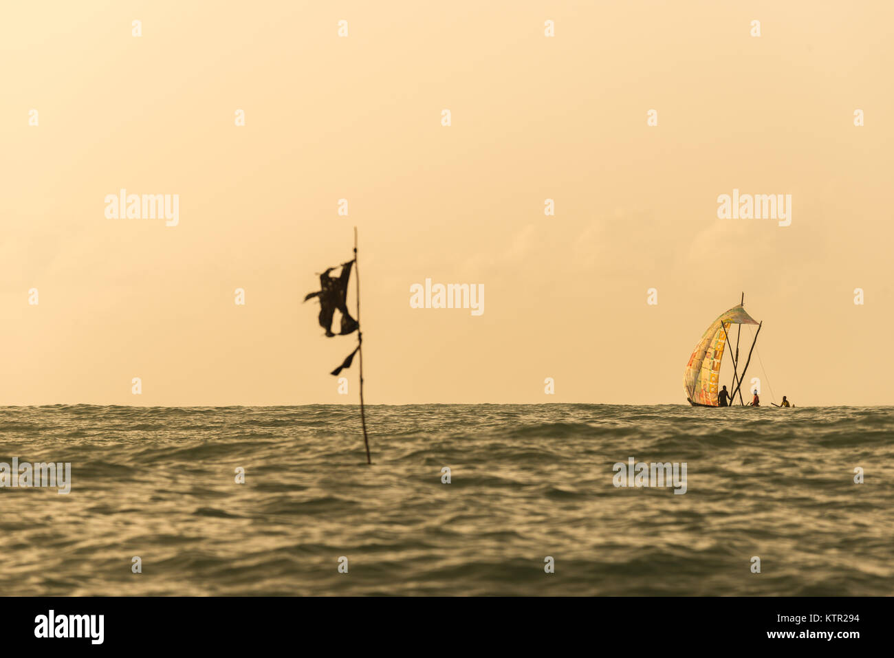 Fishermen in an open boat sailing along the Golden Coast, Central ...