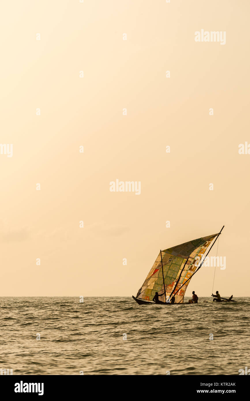 Fishermen in an open boat sailing along the Golden Coast, Central ...