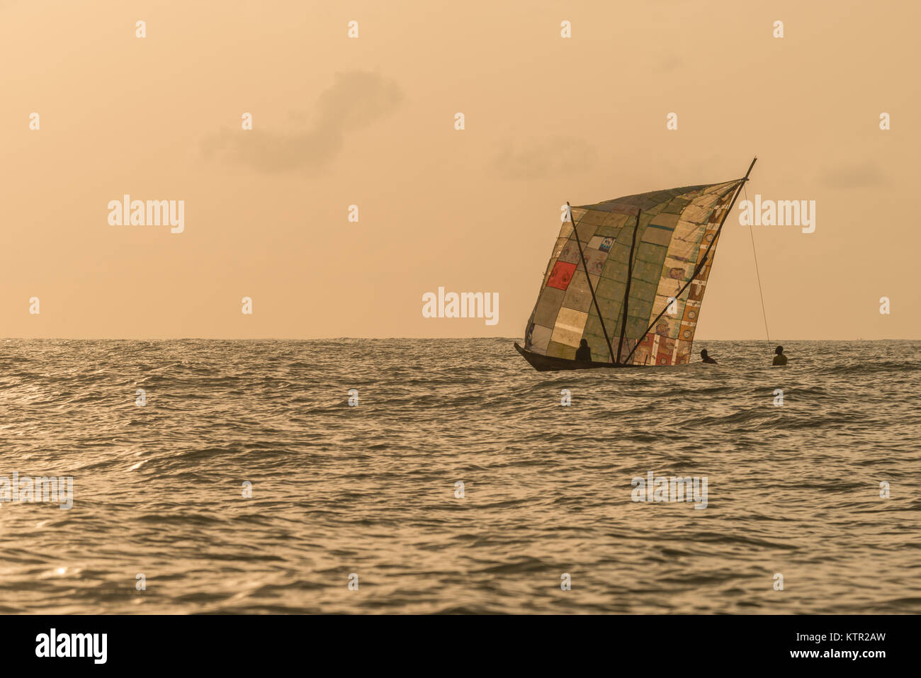 Fishermen in an open boat sailing along the Golden Coast, Central ...