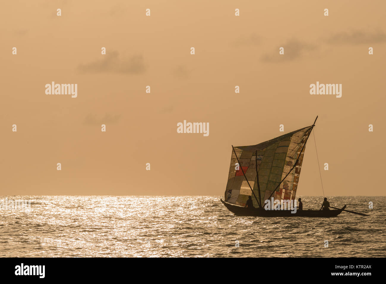 Fishermen in an open boat sailing along the Golden Coast, Central ...