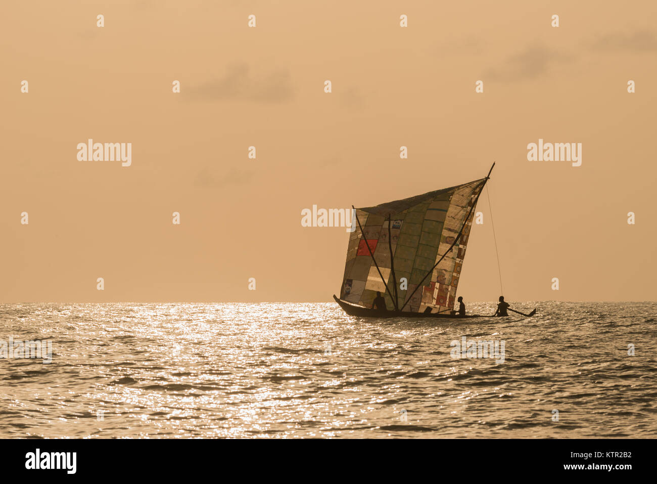 Fishermen in an open boat sailing along the Golden Coast, Central ...
