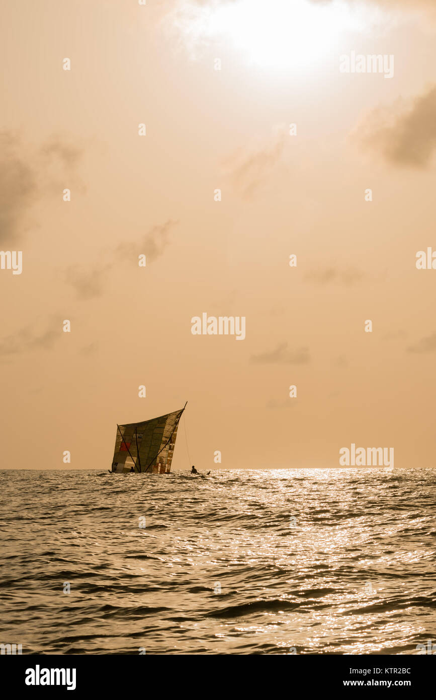 Fishermen in an open boat sailing along the Golden Coast, Central ...