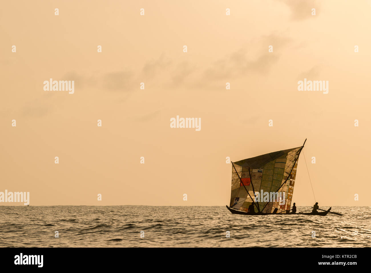 Fishermen in an open boat sailing along the Golden Coast, Central ...