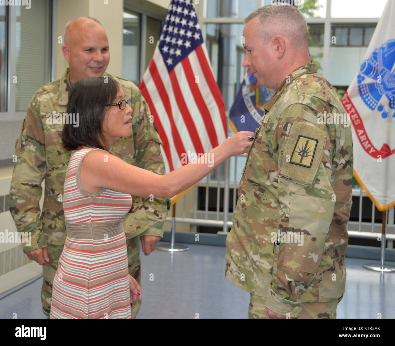 Lt. Col. Chris Kellerman ( far right) receives his new rank insignia ...