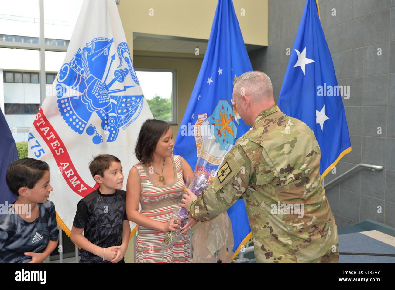 Lt. Col. Chris Kellerman presents his wife Valerie with a bouquet of ...