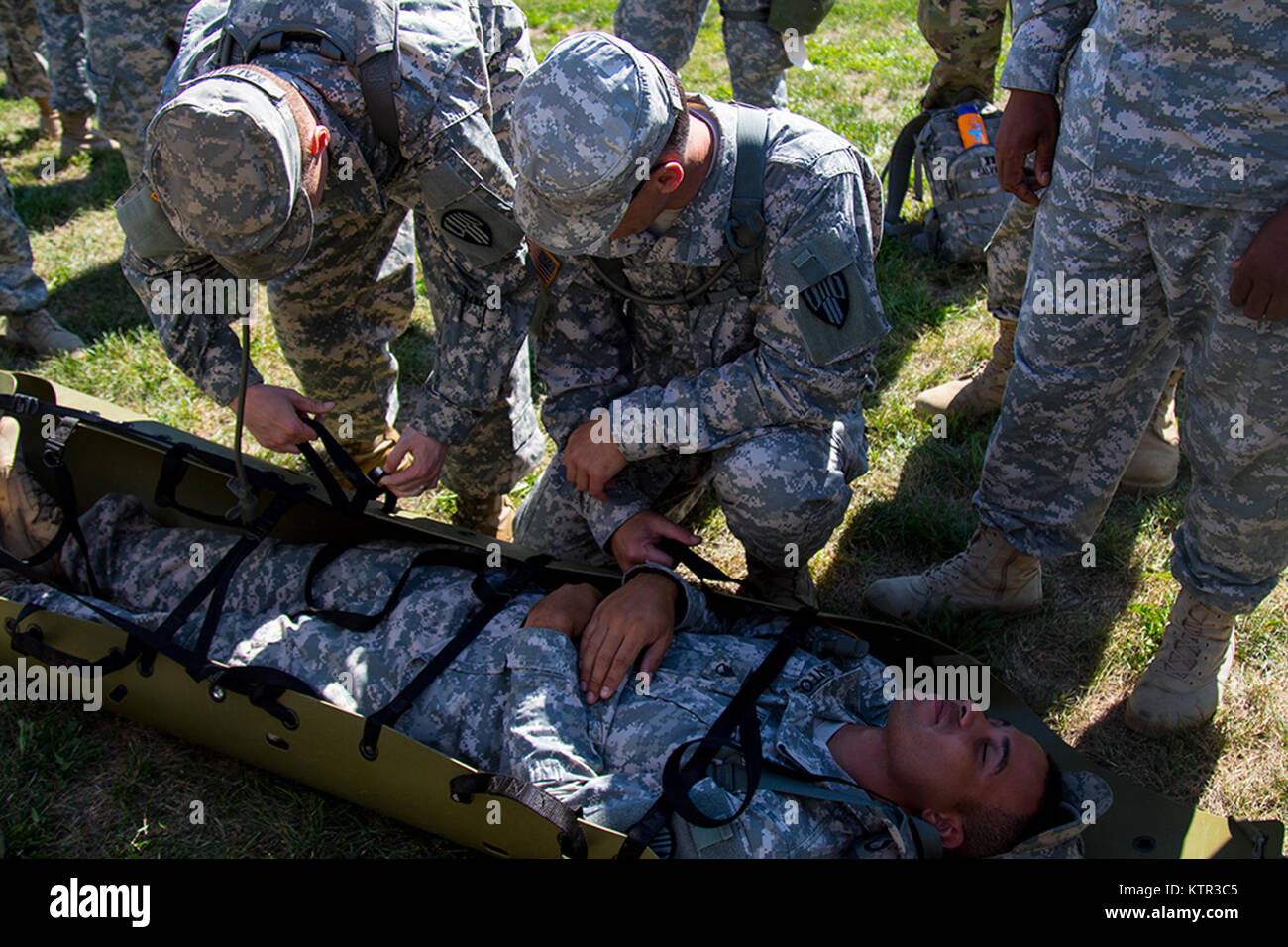 Soldiers of the 369th Sustainment Brigade, practice using a sked litter ...
