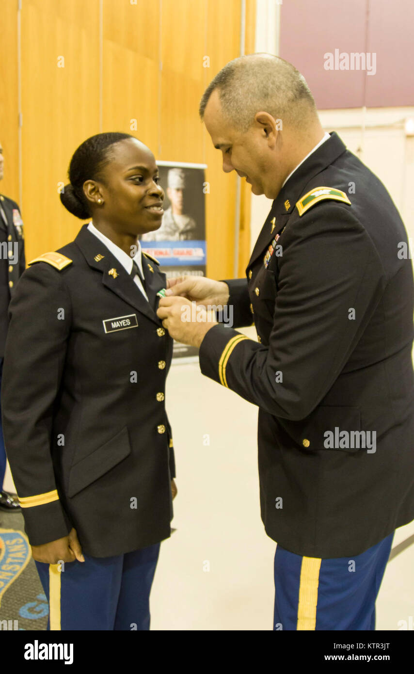 Col. David Gagnon presents 2nd Lt. Lasheri E. Mayes, a newly ...