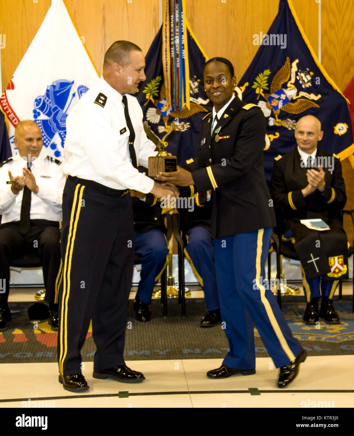 Maj. Gen. Henry E. Miller presents 2nd Lt. Lasheri E. Mayes, a newly ...